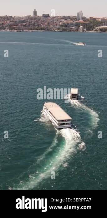 Aerial view of a ferry on the Bosphorus, berthed ships, city by the sea ...