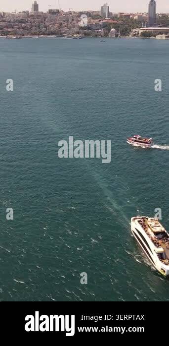 Aerial view of a ferry on the Bosphorus, berthed ships, city by the sea ...