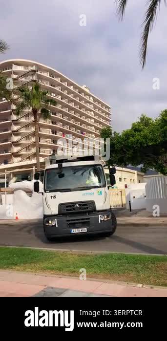 TORREMOLINOS, SPAIN - JUNE 1 2026: Garbage truck reverses in front of a ...