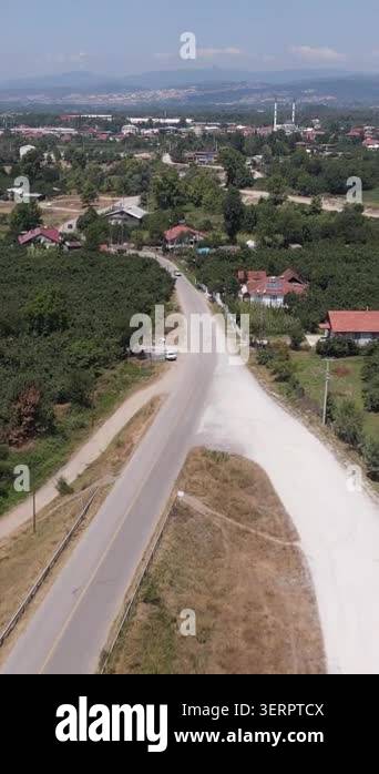 Aerial view of asphalt road with the rural area on both sides, the ...