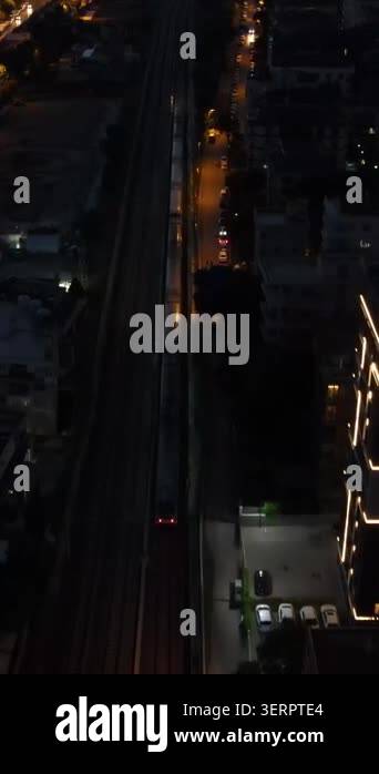 Aerial view of car traffic at night, evening city density on the beach ...