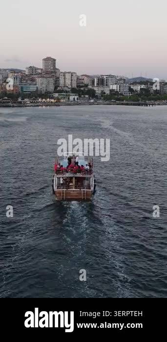 Aerial view of the ferry sailing through the sea in the big city with a ...