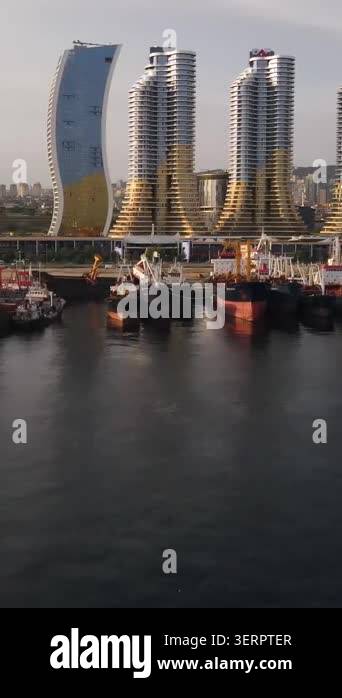 Skyscrapers behind ship port, aerial view of ships docked at the ...