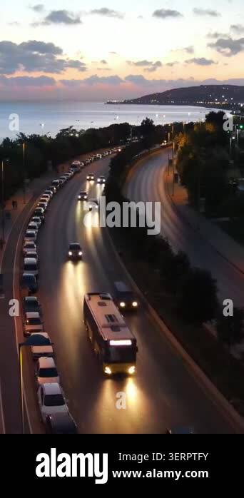 Time-lapse view of highway traffic passing by the beach in the evening ...