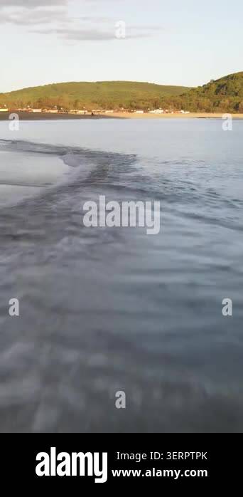 Aerial top view waves break near the beach, sea waves on dangerous ...