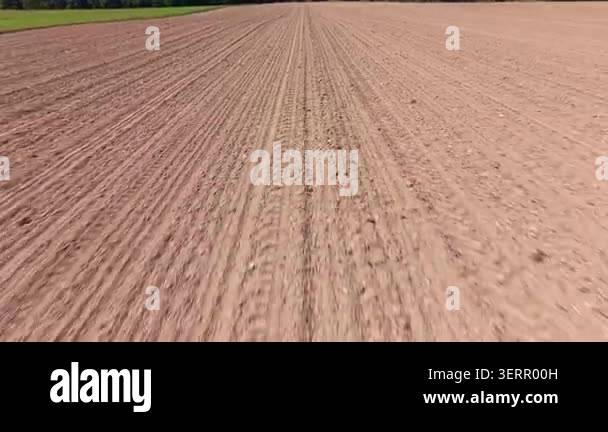 Dynamic drone view of a disk harrowed field surface. Aerial shot of ...