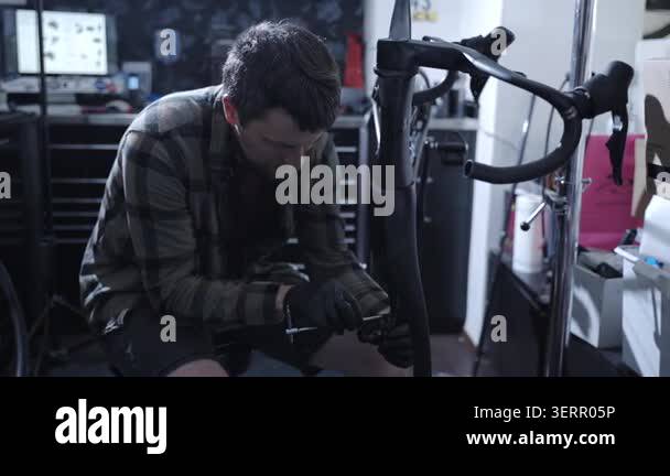 High quality bicycle workshop where a mechanic services a black carbon ...