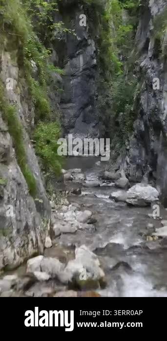 A young man walking canyon river aerial view, nature walks among the ...