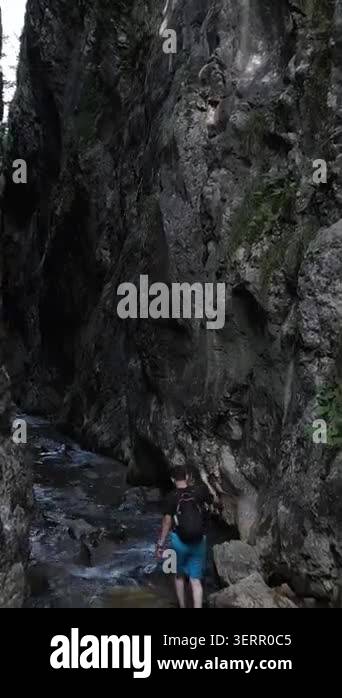 A young man walking canyon river aerial view, nature walks among the ...