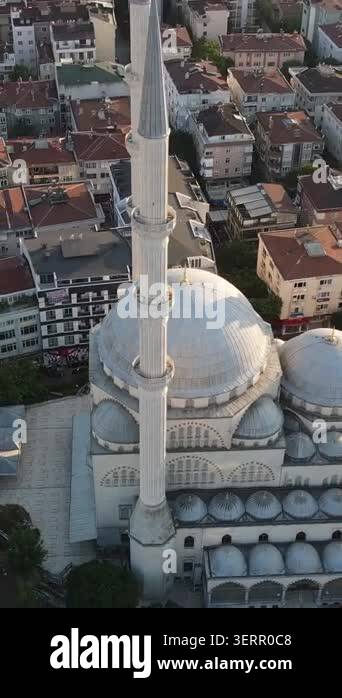 Overhead view of the mosque between the buildings, people are praying ...