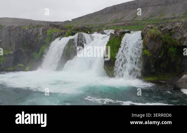 Beautiful and wild Baejarfoss waterfall on a summer evening located in ...