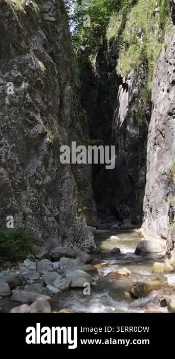 A young man walking canyon river aerial view, nature walks among the ...