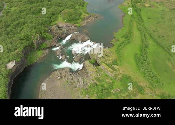 Aerial flight over the beautiful Glanni waterfall on a summer day in ...