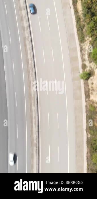 An aerial view of the two sides of a highway surrounded by trees in ...
