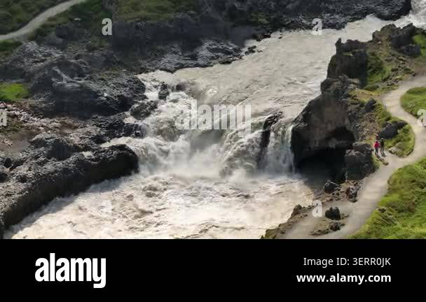 Aerial flight over the wild Geitafoss waterfall on a summer day in ...