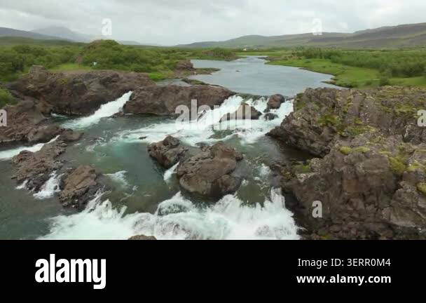Aerial flight over the beautiful Glanni waterfall on a summer day in ...