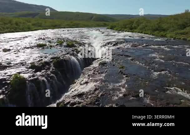 Aerial flight over the famous and beautiful Bruarfoss waterfall on a ...