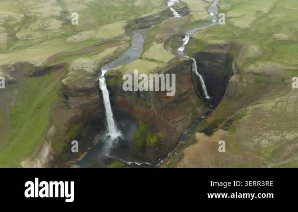 Aerial flight over the Haifoss and Grannifoss waterfall on a summer day ...