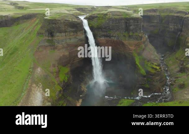 Aerial flight over the Haifoss and Grannifoss waterfall on a summer day ...