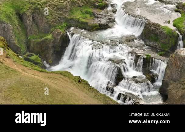 Aerial flight over the Reykjafoss waterfall on a summer day in Iceland ...