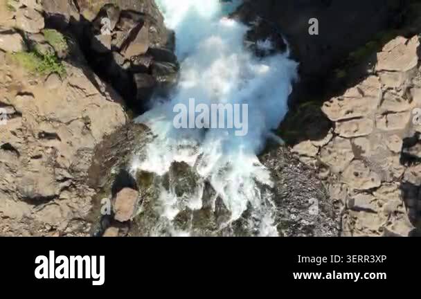 Aerial flight over the wild Nykurhylsfoss (Sveinsstekksfoss) waterfall ...