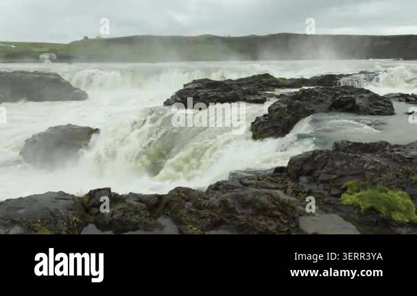 Aerial flight over the beautiful Urridafoss waterfall on a summer day ...
