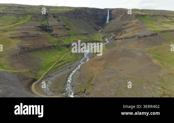 Aerial flight over the famous Hengifoss waterfall on a summer day in ...