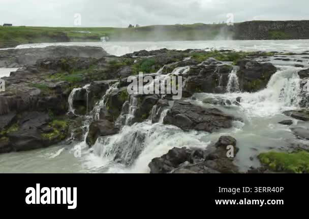 Aerial flight over the beautiful Urridafoss waterfall on a summer day ...