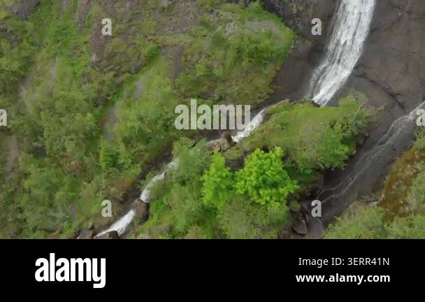 Aerial flight over the beautiful SystravatnSystrafoss waterfall on a ...