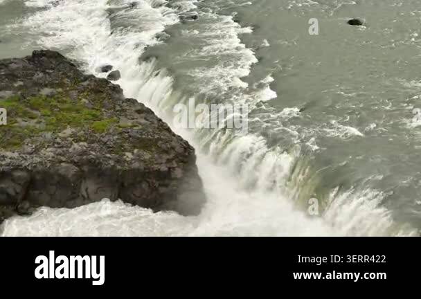 Aerial flight over the beautiful Urridafoss waterfall on a summer day ...