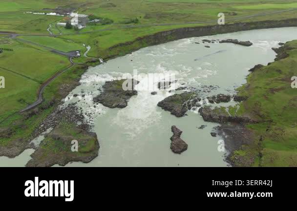 Aerial flight over the beautiful Urridafoss waterfall on a summer day ...