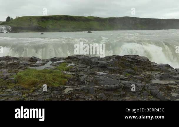 Aerial flight over the beautiful Urridafoss waterfall on a summer day ...