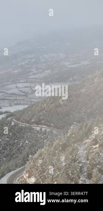 High mountains covered with snow, aerial view of snowy peaks, misty ...