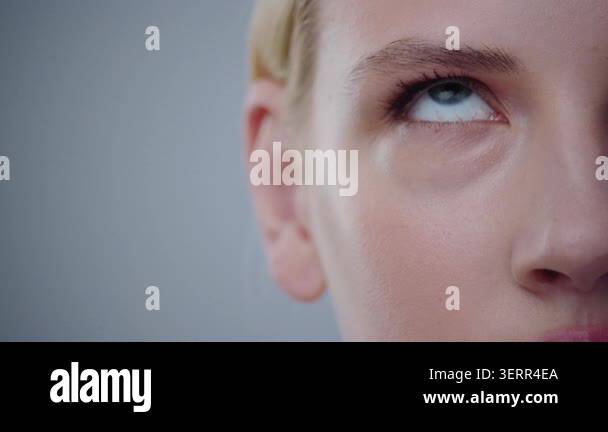 Close-up macro view of beauty female face part with blue eye rolling up ...