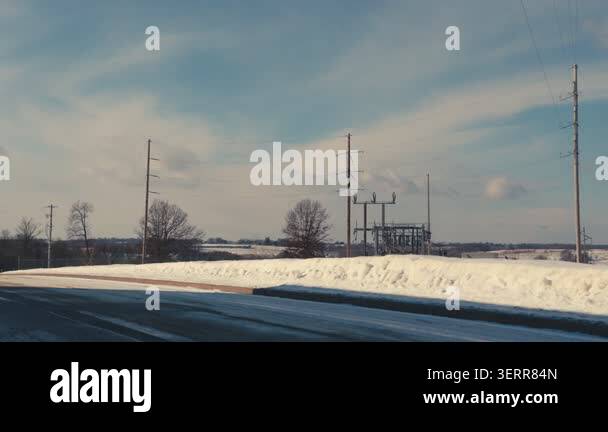 Electrical substation and power lines in a rural, snow-covered ...