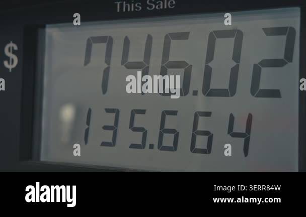 Close-up of a digital gas pump screen showing the rising cost and ...