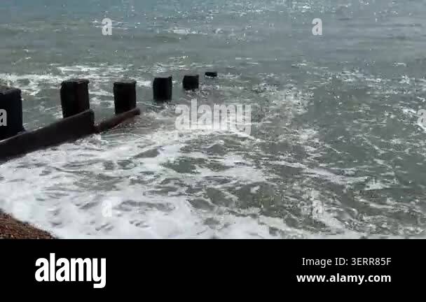 Stock video footage of a seaside wave splashing in slow motion against ...