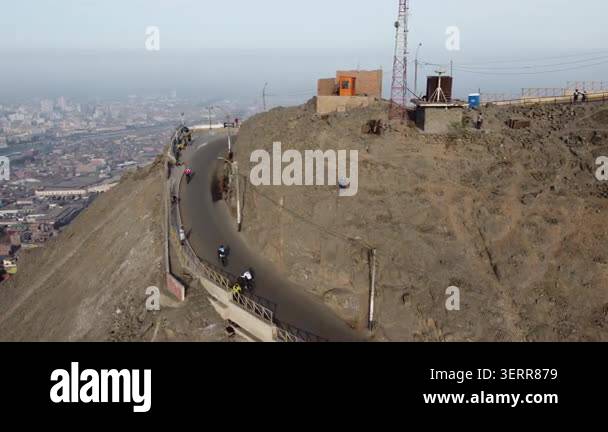 Cyclists are enjoying the view as they ascend a steep mountain road ...