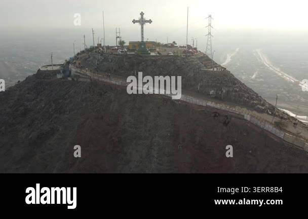 Tourists and locals gather around the cross on cerro san cristobal as ...