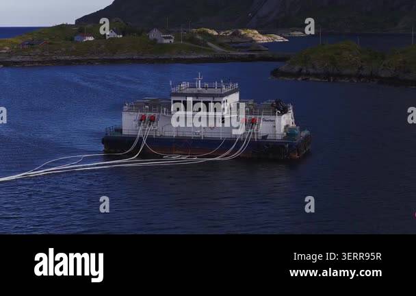 Aerial view shows white multi deck barge Fluctus moored in Lofoten ...