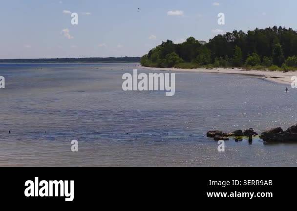 Aerial view over Jurmala, Latvia shows Baltic Sea, sandy shore, coastal ...