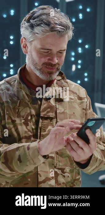 Military officer caucasian man in camouflage using smartphone ...