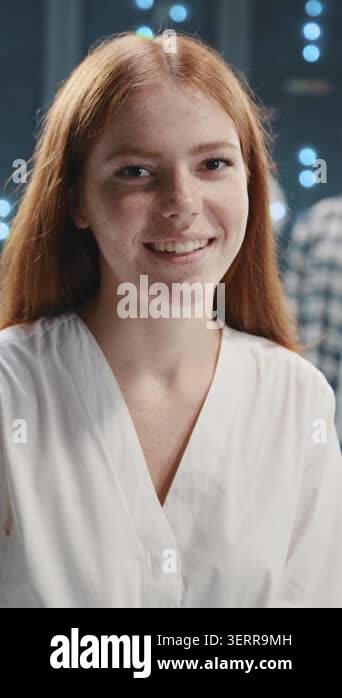 Ginger attractive young female IT specialist smiling enjoying coworking ...