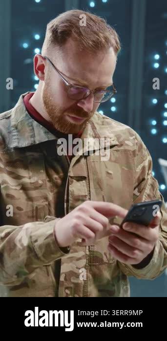 Army soldier using mobile phone network checking news on data center ...