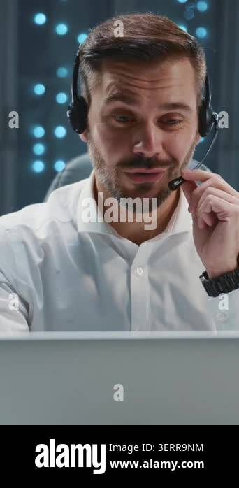 Young friendly Caucasian man with beard in headset using microphone and ...