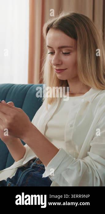 Portrait happy young woman hold cup with coffee at home sitting on sofa ...