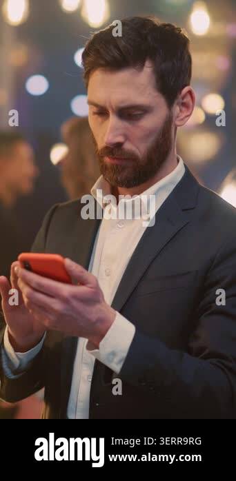 Portrait of handsome bearded caucasian executive using mobile phone ...