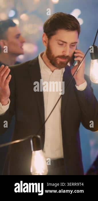Worried young caucasian businessman spending corporate party with ...