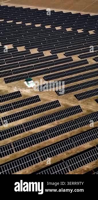 Aerial perspective of solar panels in rows on a field, highlighting the ...