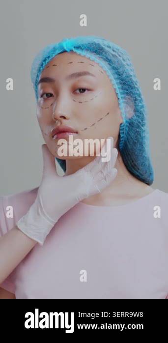 Chinese asian woman is preparing for plastic surgery. Cosmetologist ...